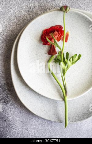 Rustic table setting with ranunculus flowers on concrete background ...