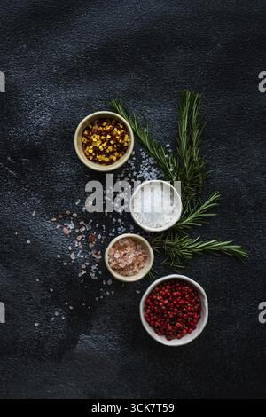Sea salt and red hot pepper with bay leaf and colorful peppercorns on ...