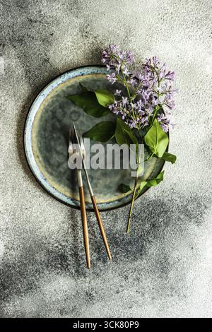 Spring table setting with beautiful flowers on grey grunge background ...