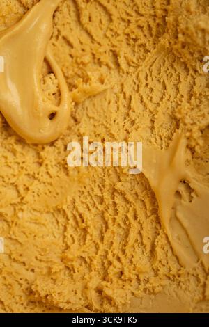 Rich vanilla flavored ice cream in cracking brown milk chocolate and ...