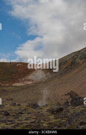 Distance view to the magnificent gray brown cliff rocks with trees and ...
