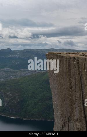 Preikestolen, a flat topped cliff in Norway, towers above Lysefjord ...