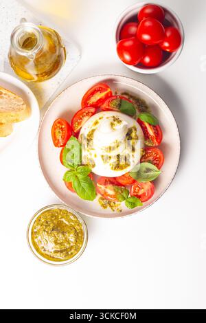 Burrata cheese, cherry tomatoes and basil. Italian cuisine. Flat lay ...