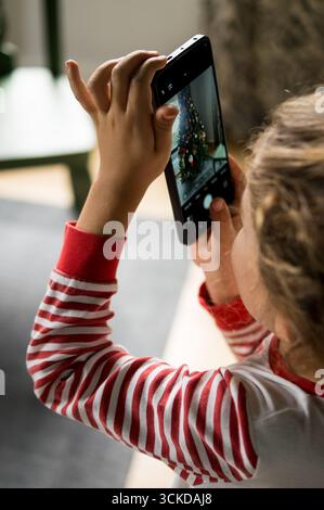 santa claus with smartphone and christmas tree Stock Photo - Alamy
