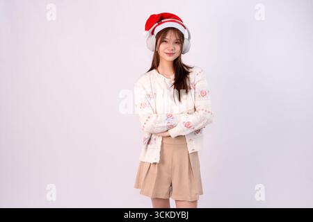 Beautiful redhead girl in santa hat open Christmas stocking and looking ...