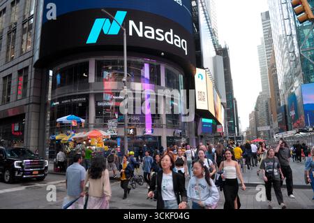 People walk past the Nasdaq MarketSite Times Square event space in ...
