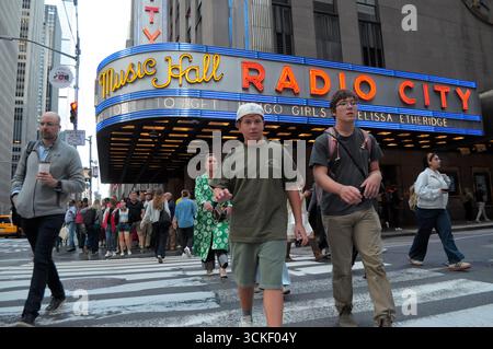 People walk past Radio City Music Hall in Manhattan, New York City ...