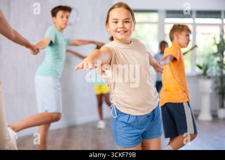 Smiling schoolchildren dancing rumba in training Stock Photo - Alamy