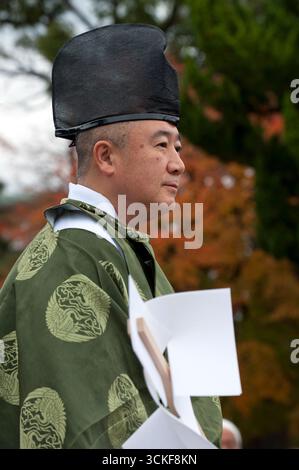 Japanese Shinto priest, kannushi, wearing eboshi hat and kariginu ...