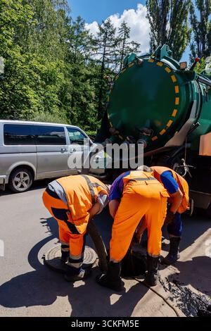 Process of cleaning up sewage collector. Pumping out sewerage and ...