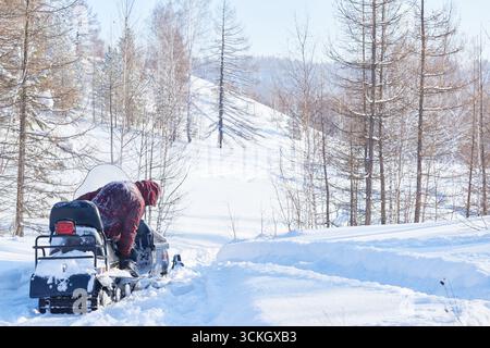 Man riding snowmobile in snowy alps during winter Stock Photo - Alamy
