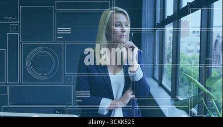 Businesswoman leaning on window sill at office Stock Photo - Alamy
