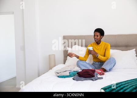 African American woman sorting coffee berries using a large bowl Stock ...