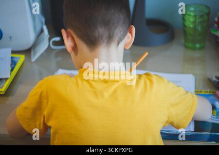 Boy draws at the table in the room Stock Photo - Alamy
