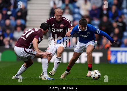 Heart of Midlothian's Harry Milne (right) heads at goal during the ...