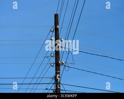 An electric wire hanging on the post Stock Photo - Alamy