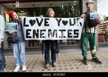 Anti-racist activists hold up a placard declaring their hatred of ...