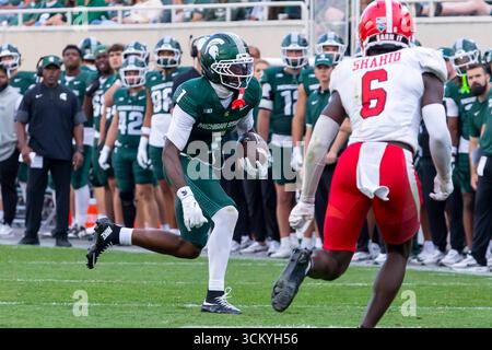 Michigan State wide receiver Omari Kelly, left, carries the ball ...