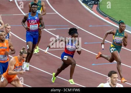 Lynna Irby-Jackson (USA) hands the baton off to Jenoah McKiver (USA) as ...