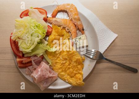 Omelet with cheese served on white plate Stock Photo - Alamy