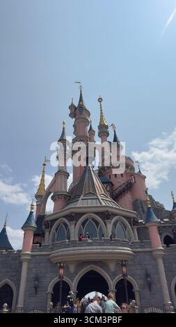 The gate to amusement park with the castles, towers, toy train on the ...