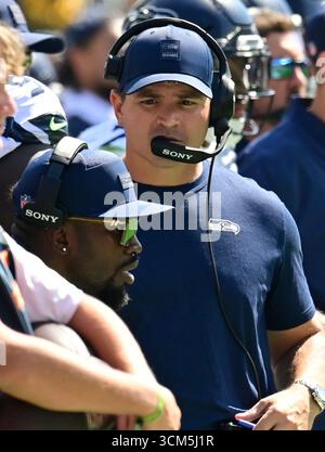 Seattle Seahawks head coach Mike Macdonald, right, watches as players ...