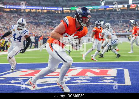 Denver Broncos tight end Adam Trautman (82) drinks from a Gatorade ...