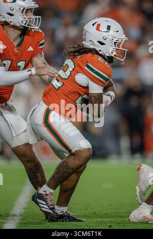 Miami running back Girard Pringle Jr. (22) carries as he's defended by ...