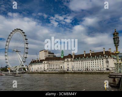 The London Eye on the banks of the River Thames beside County Hall ...