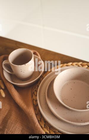 Set of dinnerware on beige background Stock Photo - Alamy