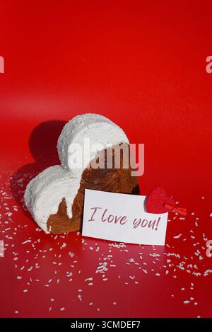Heart shaped coconut flavor croissant on red background with copy space ...