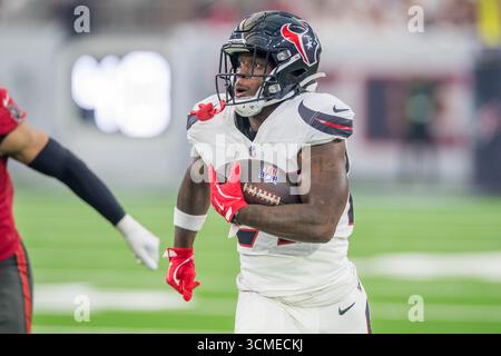 Houston Texans running back Woody Marks, left, runs for a first down ...