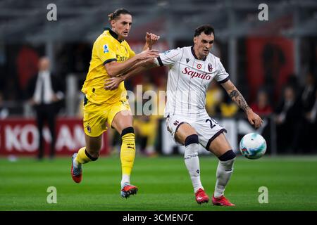 Adrien Rabiot of AC Milan competes for the ball with Nikola Stulic of ...
