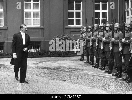 German Chancellor Adolf Hitler passes a saluting tank detachment lined ...
