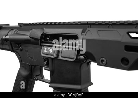 A close-up of the upper receiver and ejection port of a tan modern ...