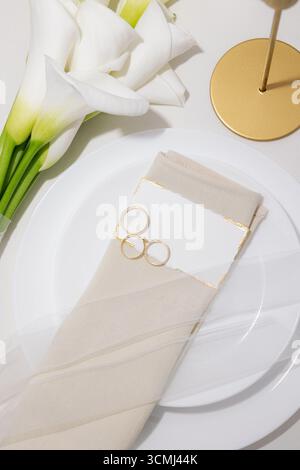 Beautiful table setting with calla lilies on pink background, top view ...