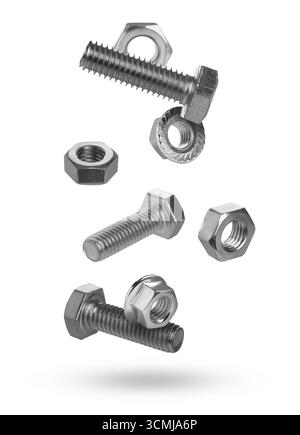 Metal nuts and bolts falling against white background Stock Photo - Alamy