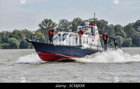 Police officers on a boat patrol near a cargo aircraft that skidded off ...