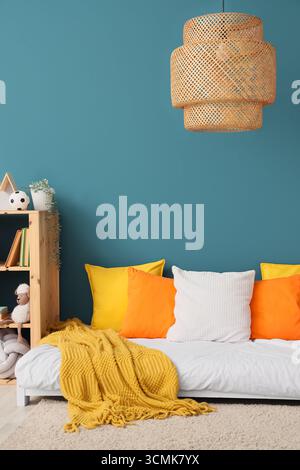 Comfortable children's bed near color wall in stylish room Stock Photo ...