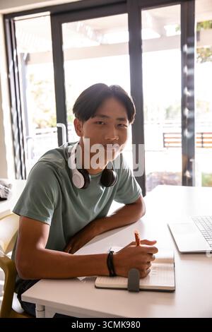 casual teenager with laptop. over white background Stock Photo - Alamy