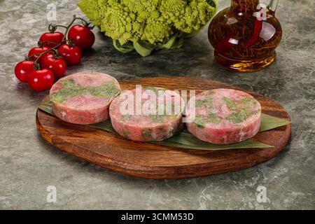 Raw Tuna medallion with broccoli cabbage Stock Photo - Alamy