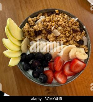 Yogurt bowl with fresh sliced strawberries and dry corn flakes ...