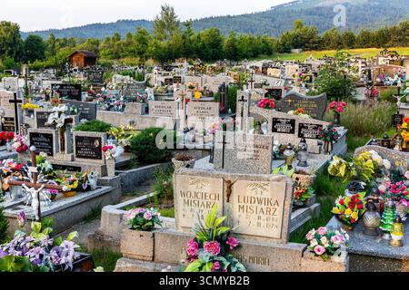 Flowers and candles on a colorful polish cemetery. Autumn, preparations ...