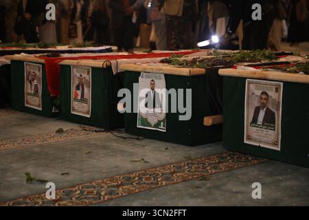 Men gather during a funeral procession for victims of a house collapse ...