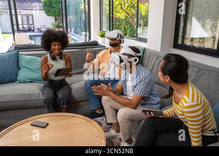 Friends playing virtual reality games using joysticks while sitting on ...