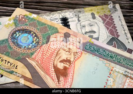 Obverse sides of an old Saudi Arabia 10 ten riyals banknote with 10 LE ...