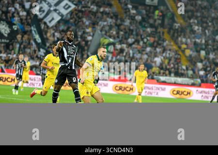 Udinese's Keinan Davis in action hindered by Lazio's Reda Belahyane ...