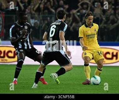 Luka Modric of AC Milan competes for the ball with Nicolae Stanciu of ...