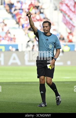 Referee Robert Hartmann shows the yellow card Wolfsburg, November 22 ...