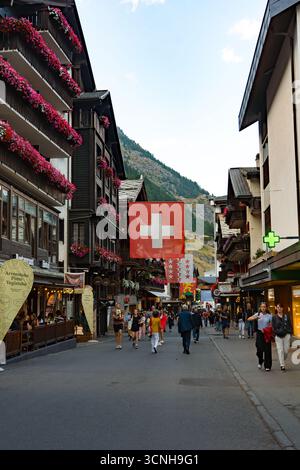 Evening scene in Zermatt town center with tourists, restaurants, shops ...